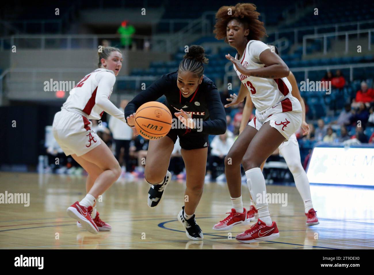 Louisville guard Sydney Taylor, center, chases the ball to keep it in ...