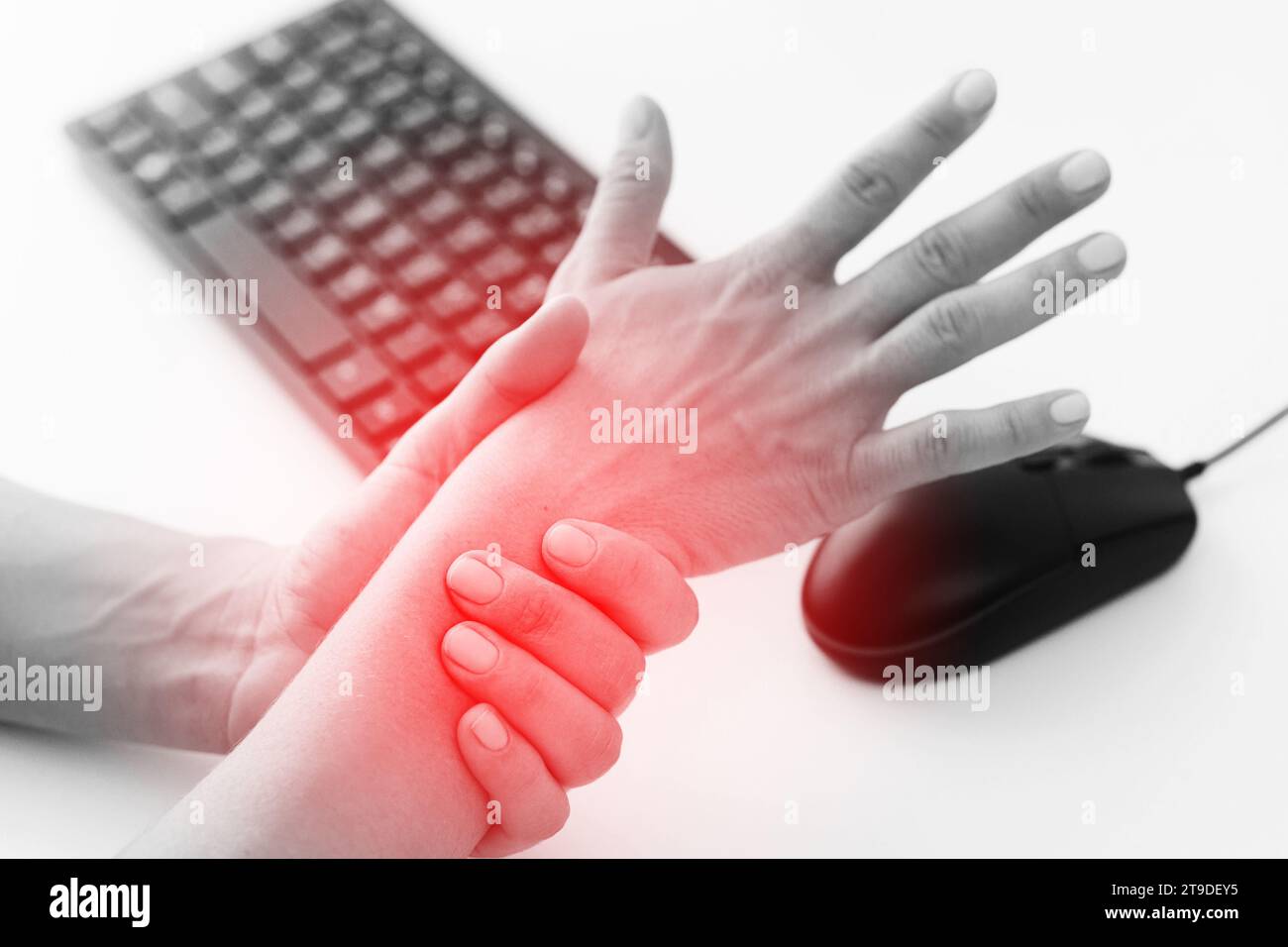 Young woman working in office with a carpal tunnel syndrome or wrist joint inflammation Stock ...