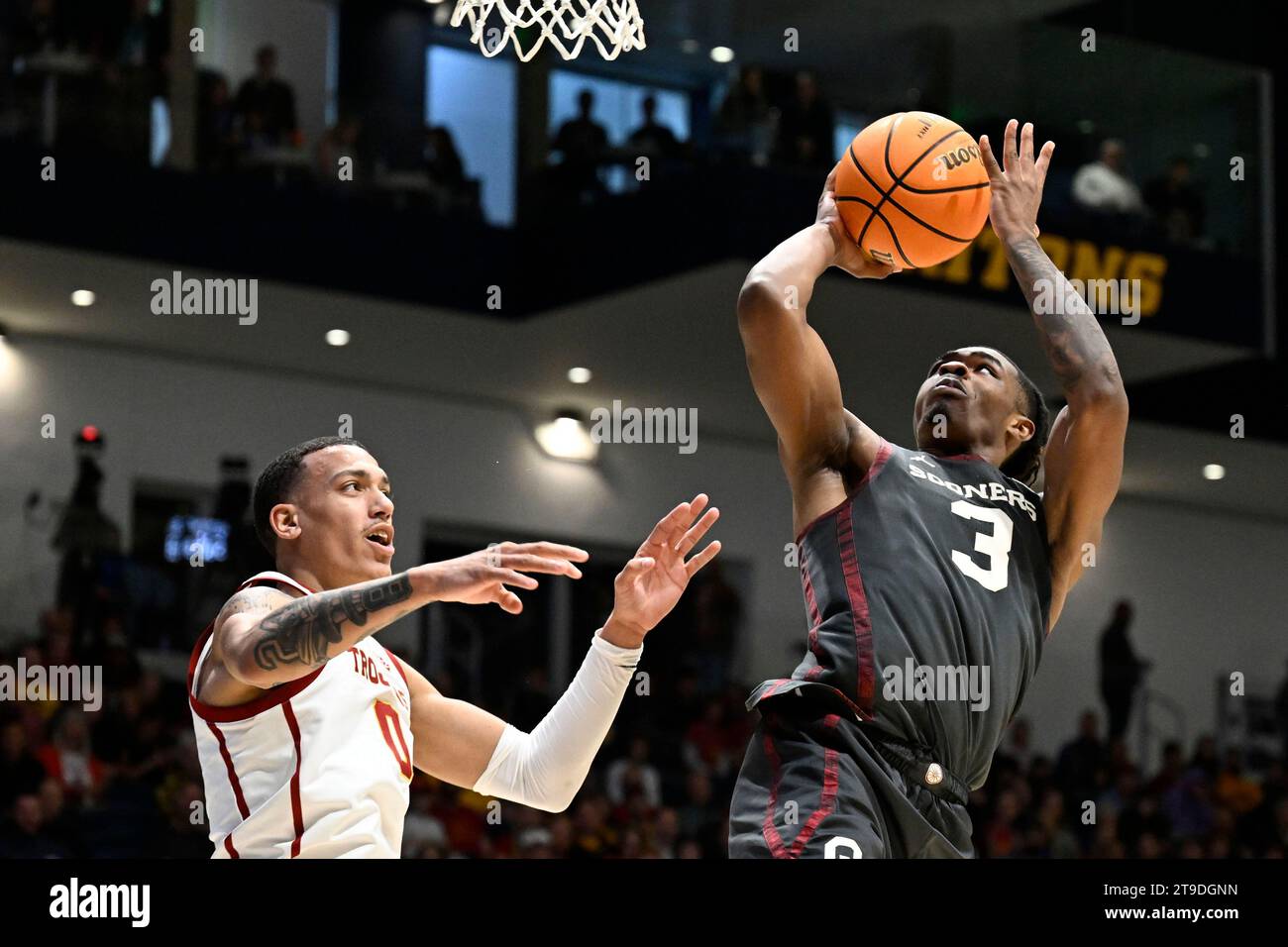 Oklahoma guard Otega Oweh (3) shoots over Southern California guard Kobe Johnson (0) during the ...
