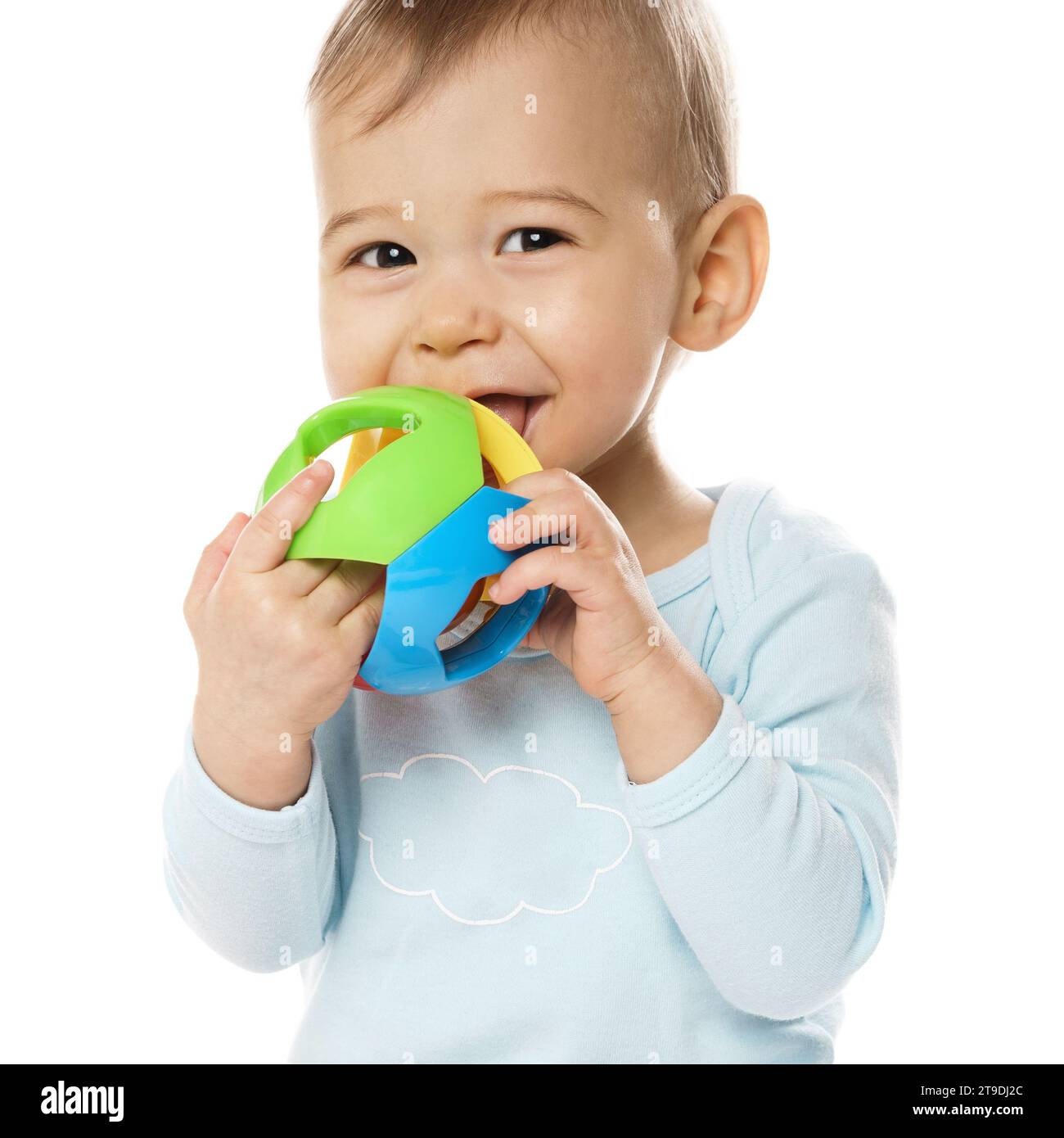 Adorable little boy in a romper is playing with plastic toy and putting ...