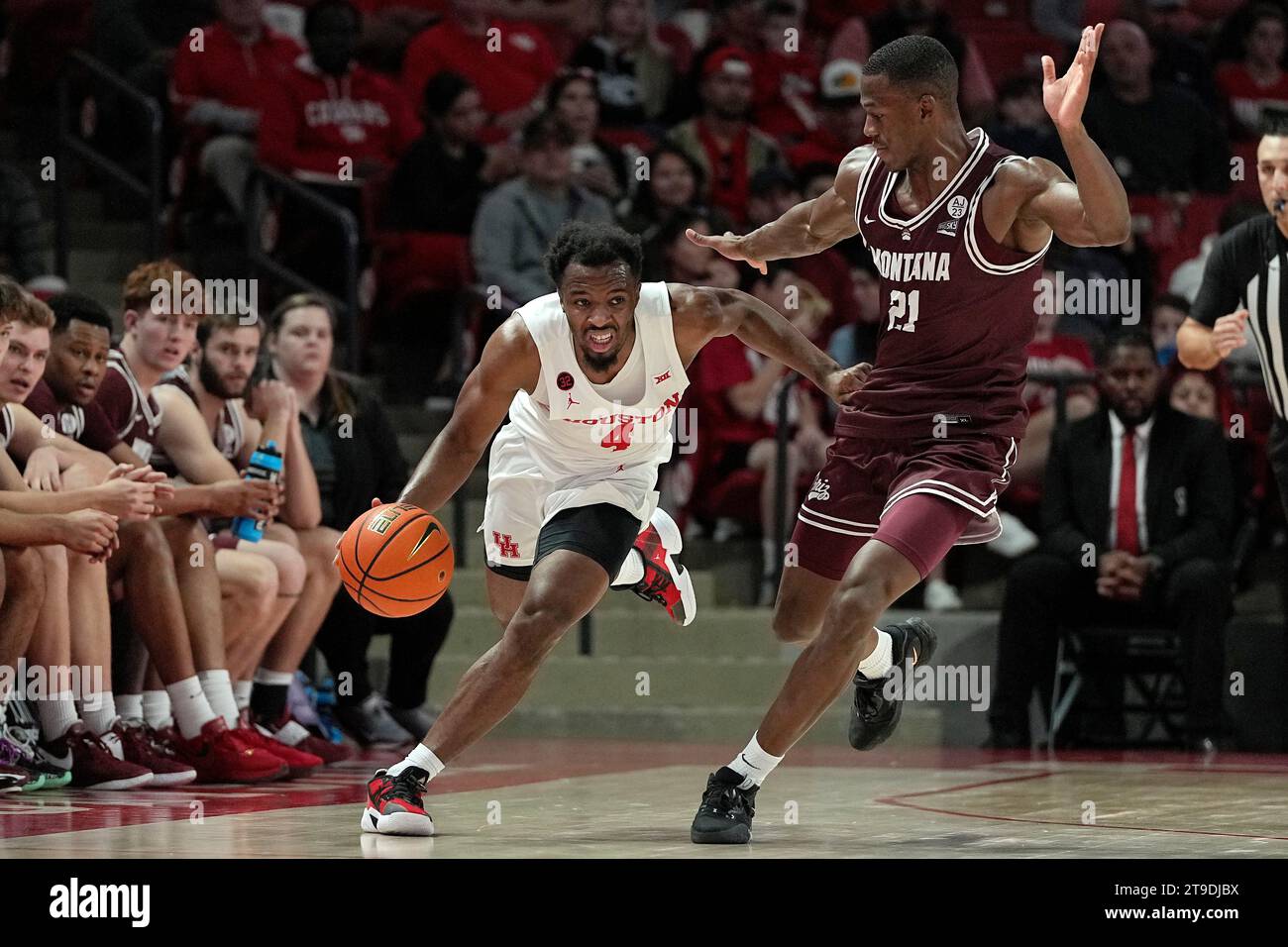 Houston guard LJ Cryer (4) drives around Montana forward Laolu Oke (21 ...