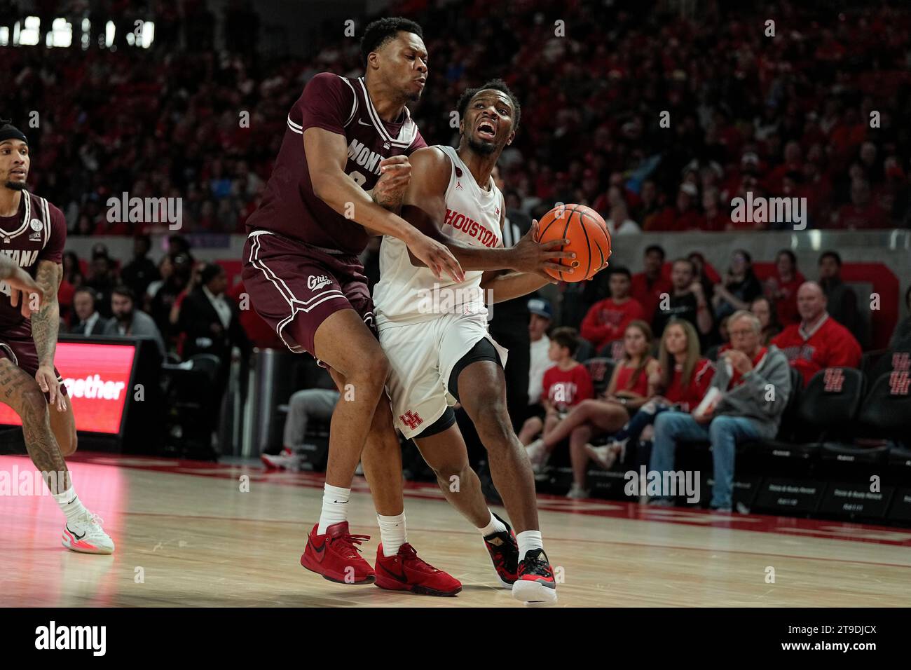 Montana forward Dischon Thomas, center left, fouls Houston guard LJ ...