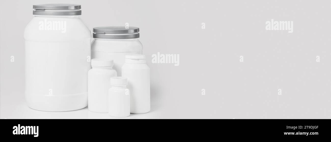 Mockup of white food supplement jars on gray background Stock Photo - Alamy