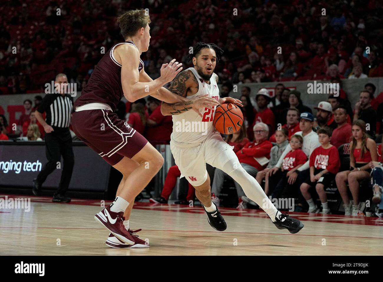 Houston guard Emanuel Sharp (21) is defended by Montana forward Jaxon ...