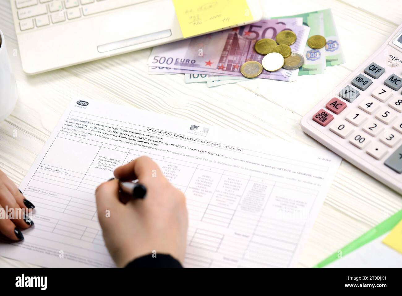 KYIV, UKRAINE - OCTOBER 31, 2023 Accountant fill french tax form 2041E ...