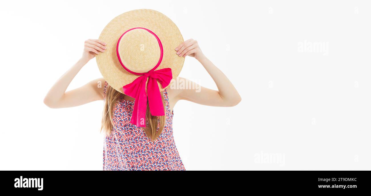 Beautiful slim girl hide her face behind a summer hat isolated on white ...