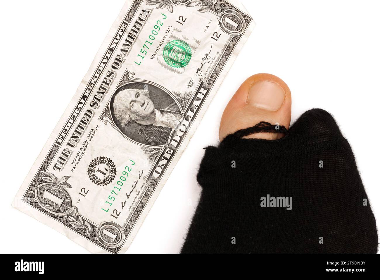 Closeup shot of a male foot in a black hoaly sock with sticking out toe ...