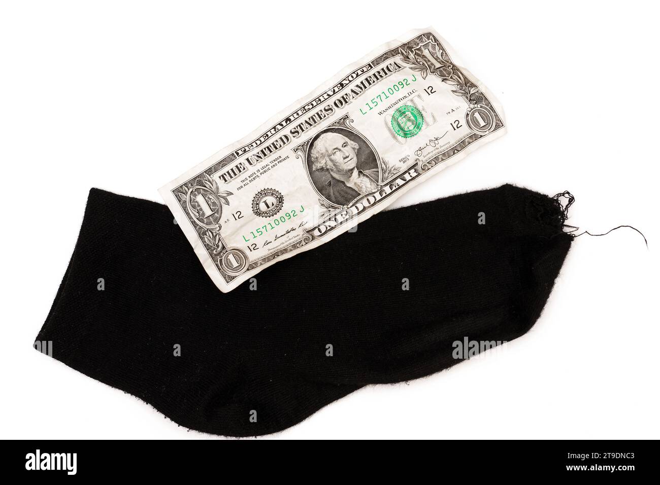 Closeup shot of a one dollar bill and a black hoaly sock on white ...