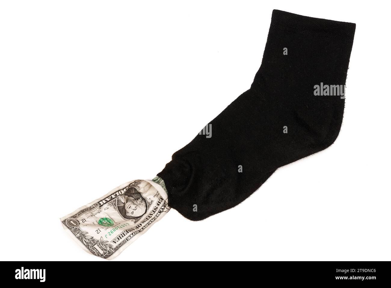 Closeup shot of an old black sock with a one dollar banknote sticking ...