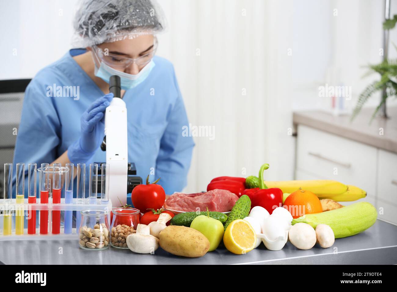 Scientist checking products at table in laboratory. Quality control ...