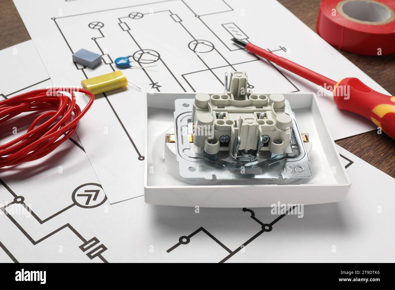 Wiring diagrams, wires and disassembled light switch on wooden table ...