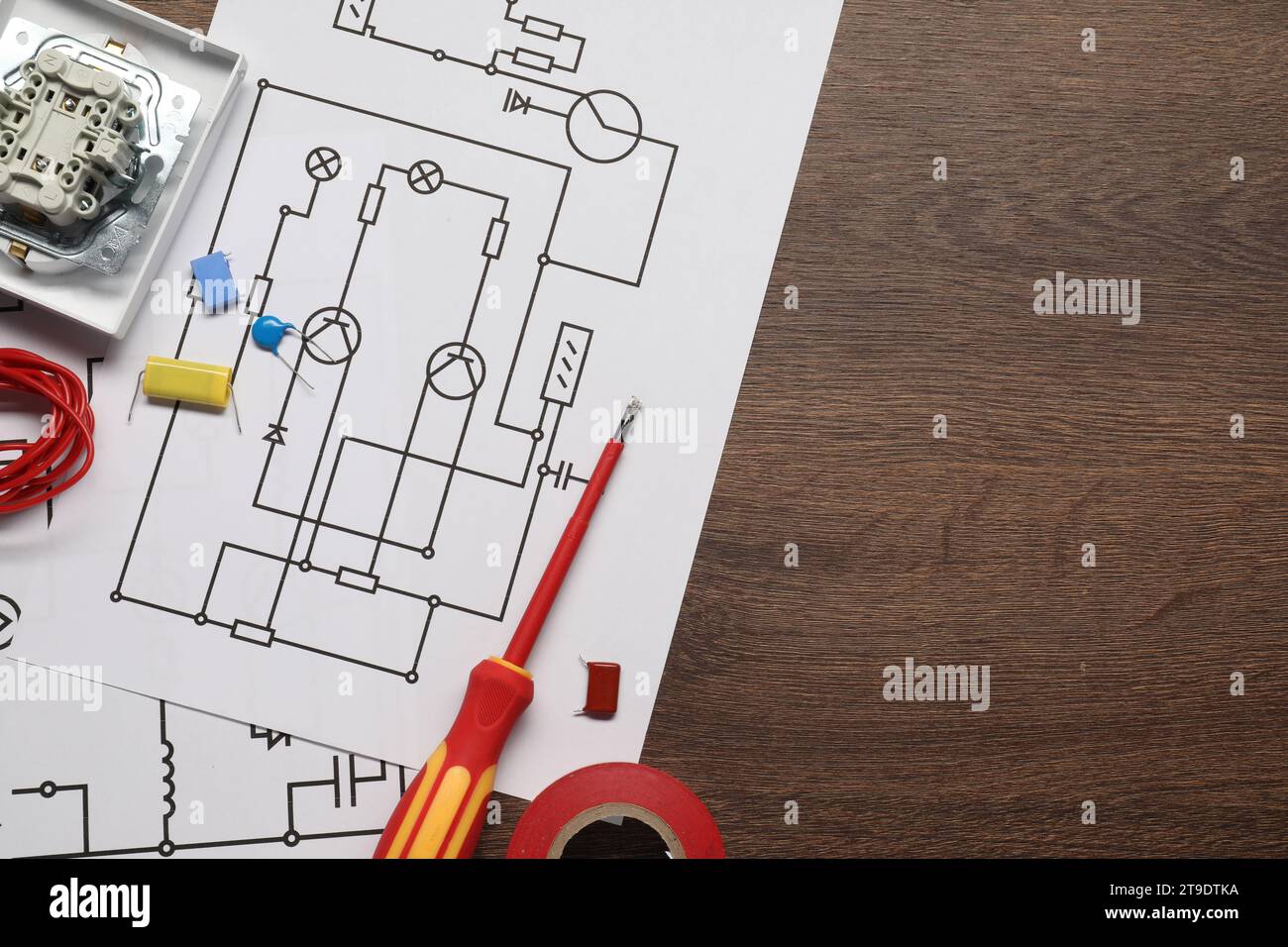 Wiring diagrams, wires and disassembled light switch on wooden table ...