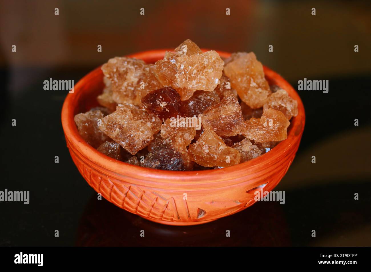Cubes of organic palm tree rock sugar in a bowl on a black background ...
