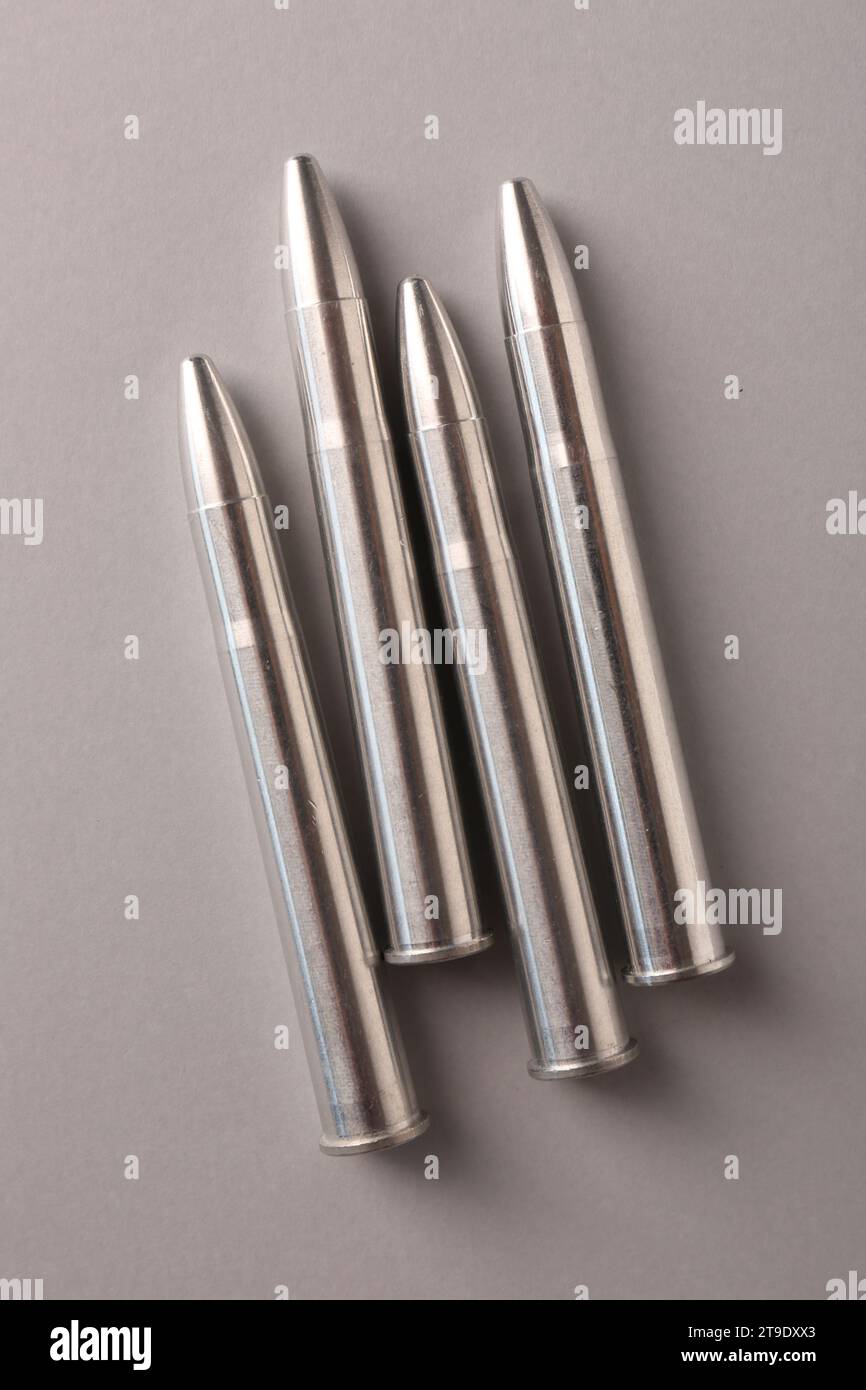 Many metal bullets on light grey background, flat lay Stock Photo - Alamy