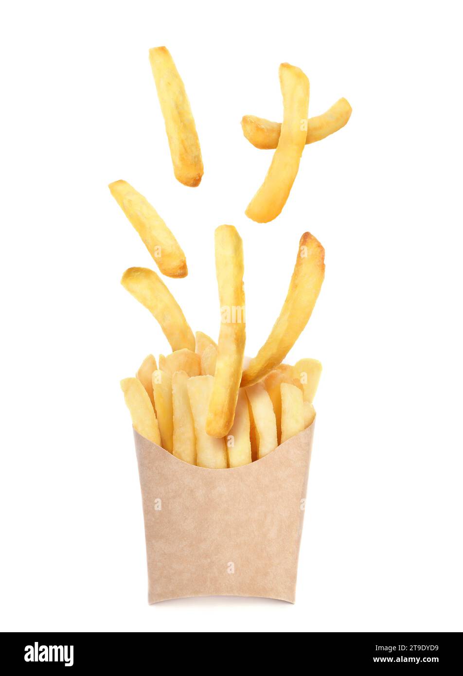 Tasty French fries falling into paper takeaway container on white ...