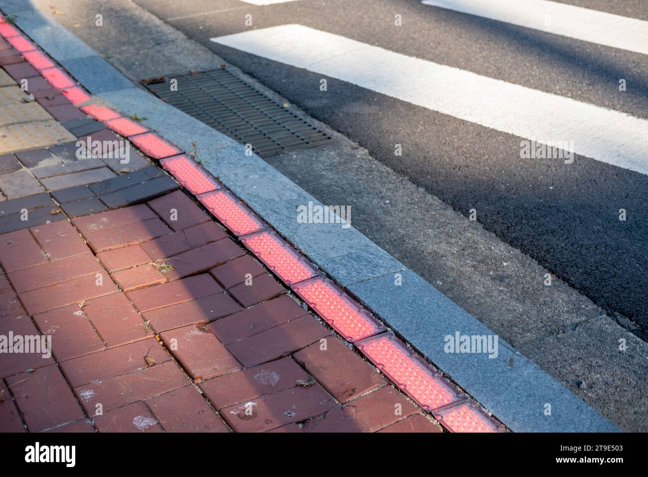 Street crossing in Seoul. The red light on the floor indicates that ...