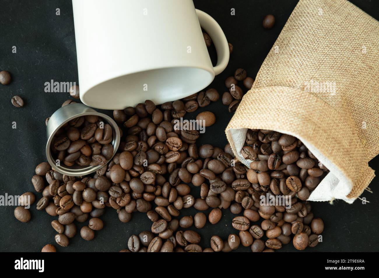 Coffee beans in refillable coffee capsules, coffee bags and around on a ...