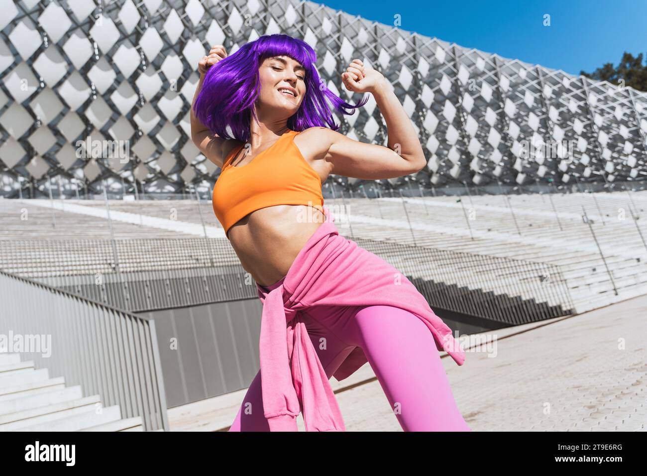 Carefree active woman dancer wearing colorful sportswear having fun on ...