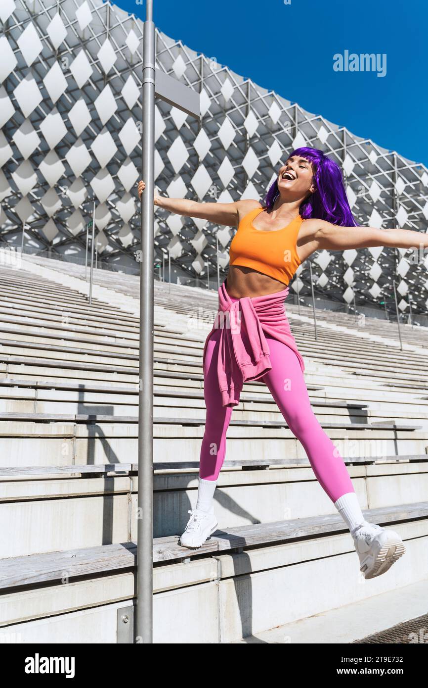 Carefree woman dancer wearing colorful sportswear having fun on the ...