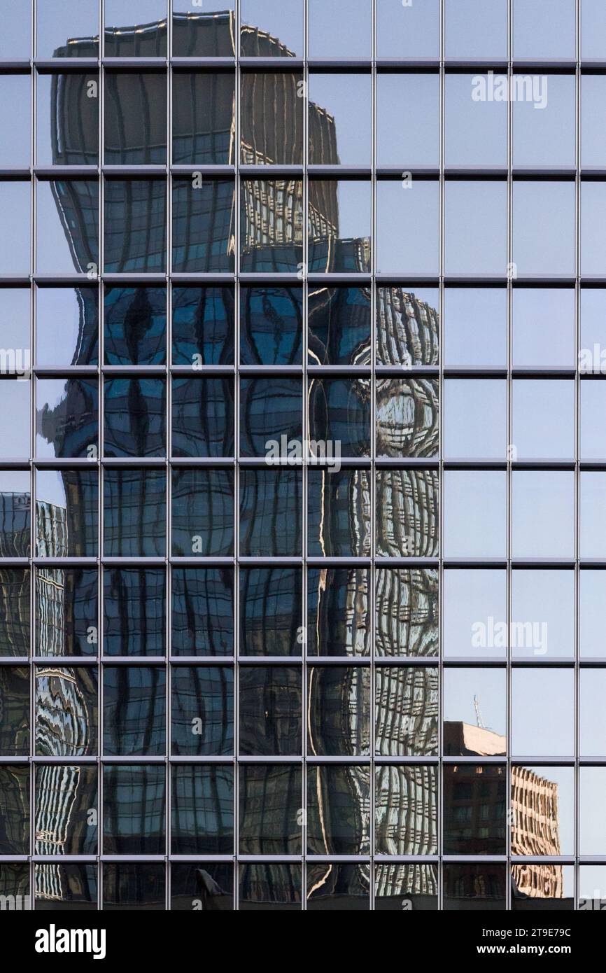 Modern office towers reflected and distorted in the windows of a building in Otemachi, Tokyo ...