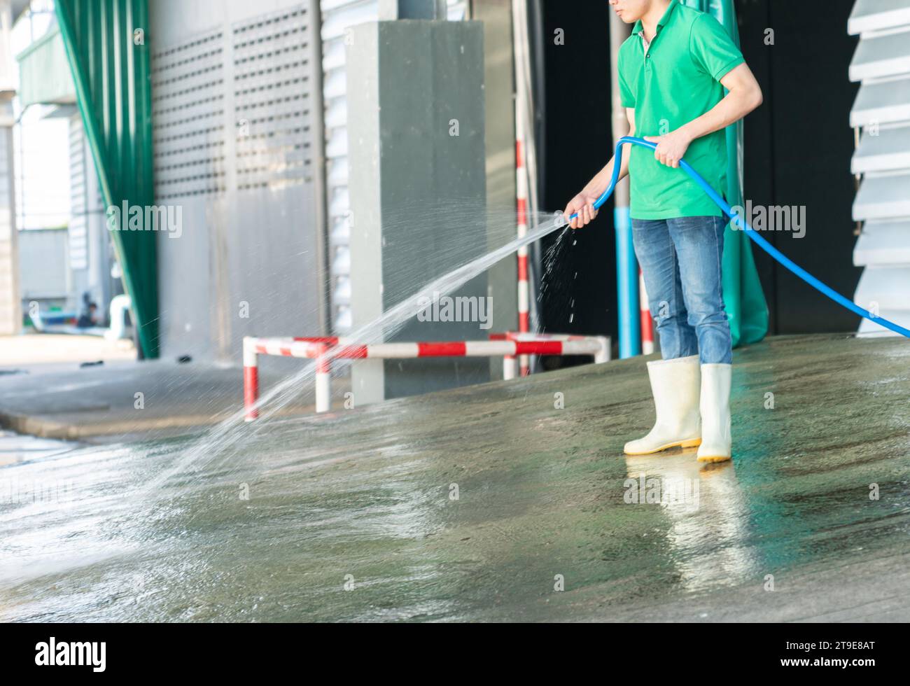 Staff cleaning floor with hoses washing the concrete floor with water ...