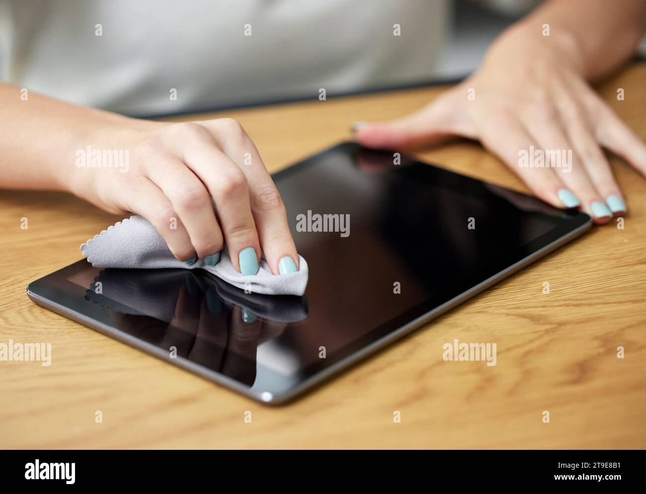 Hand, wipe tablet and cloth for screen, dust and dirt with shine on ...