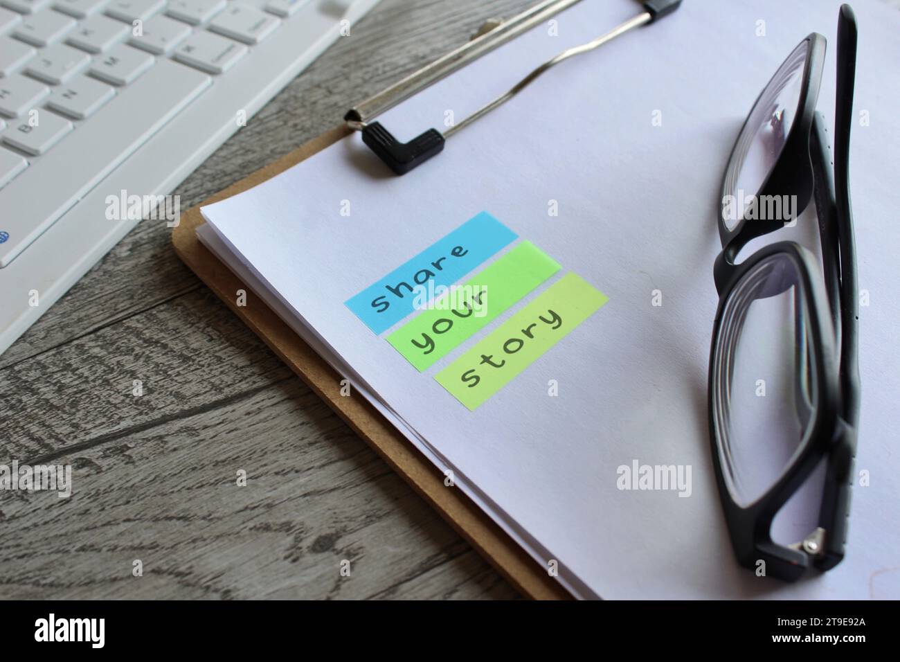 Closeup image of paper clipboard with text SHARE YOUR STORY Stock Photo ...