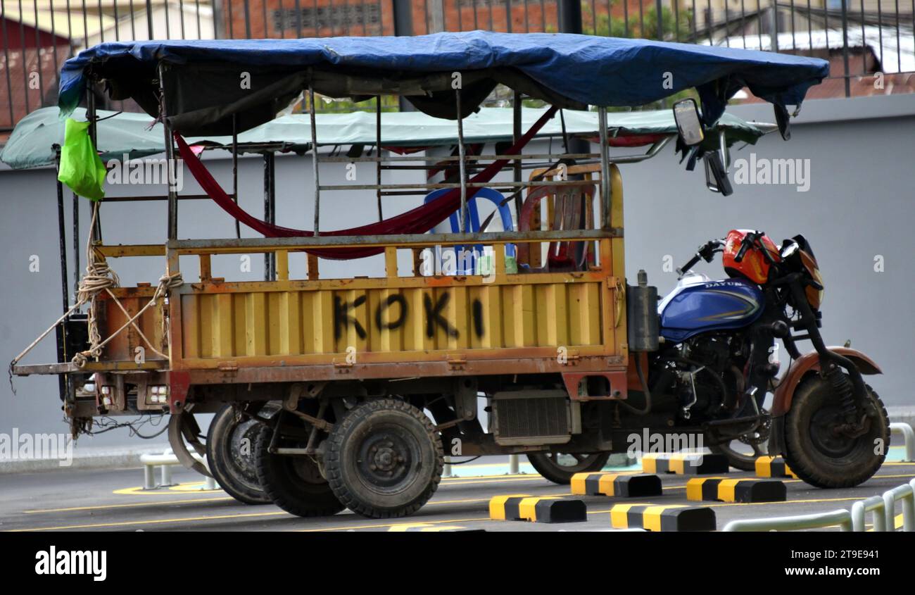 large tuk tuk, pulled by a motorbike, a very common taxi in Phnom Penh ...