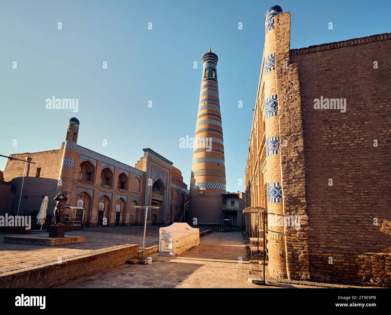 Old medieval square and Flutist statue and high Minaret at square in ...