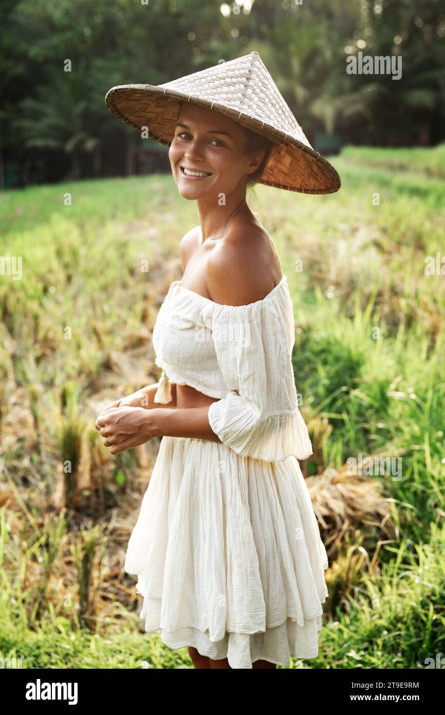 Happy smiling woman wearing natural clothes and Asian conical hat in ...
