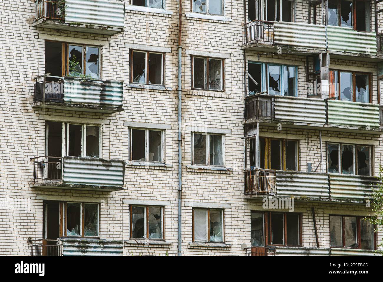 Exterior of an abandoned apartment building with broken windows in a ...