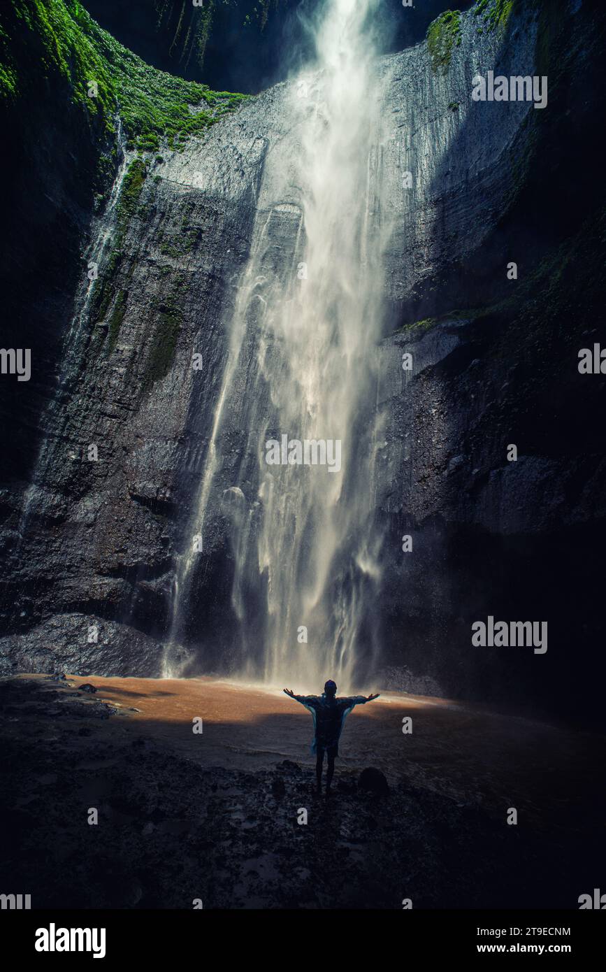 A yoga man in front of the beautiful view of Madakaripura Waterfall ...