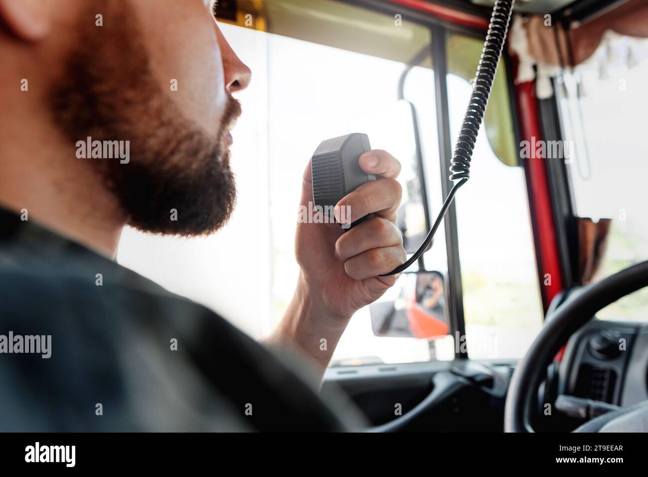 Male truck driver talking by CB radio system in his vehicle Stock Photo ...