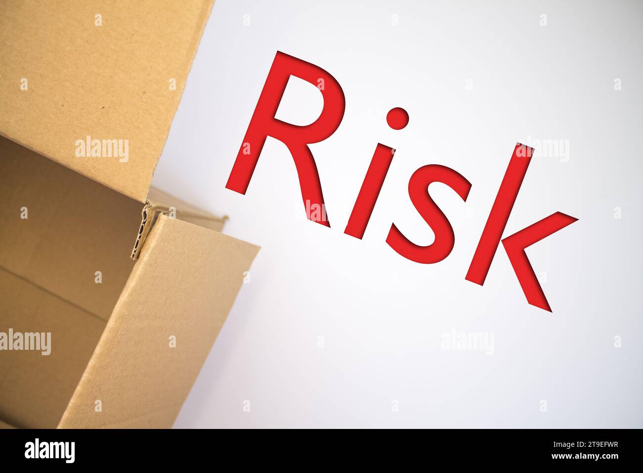 Risk word with cardboard box. Brown folded card box Stock Photo - Alamy