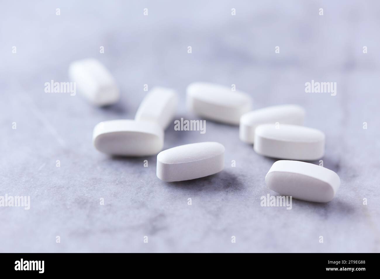 Beta - Alanine tablets. A dietary supplement on bright stone background ...