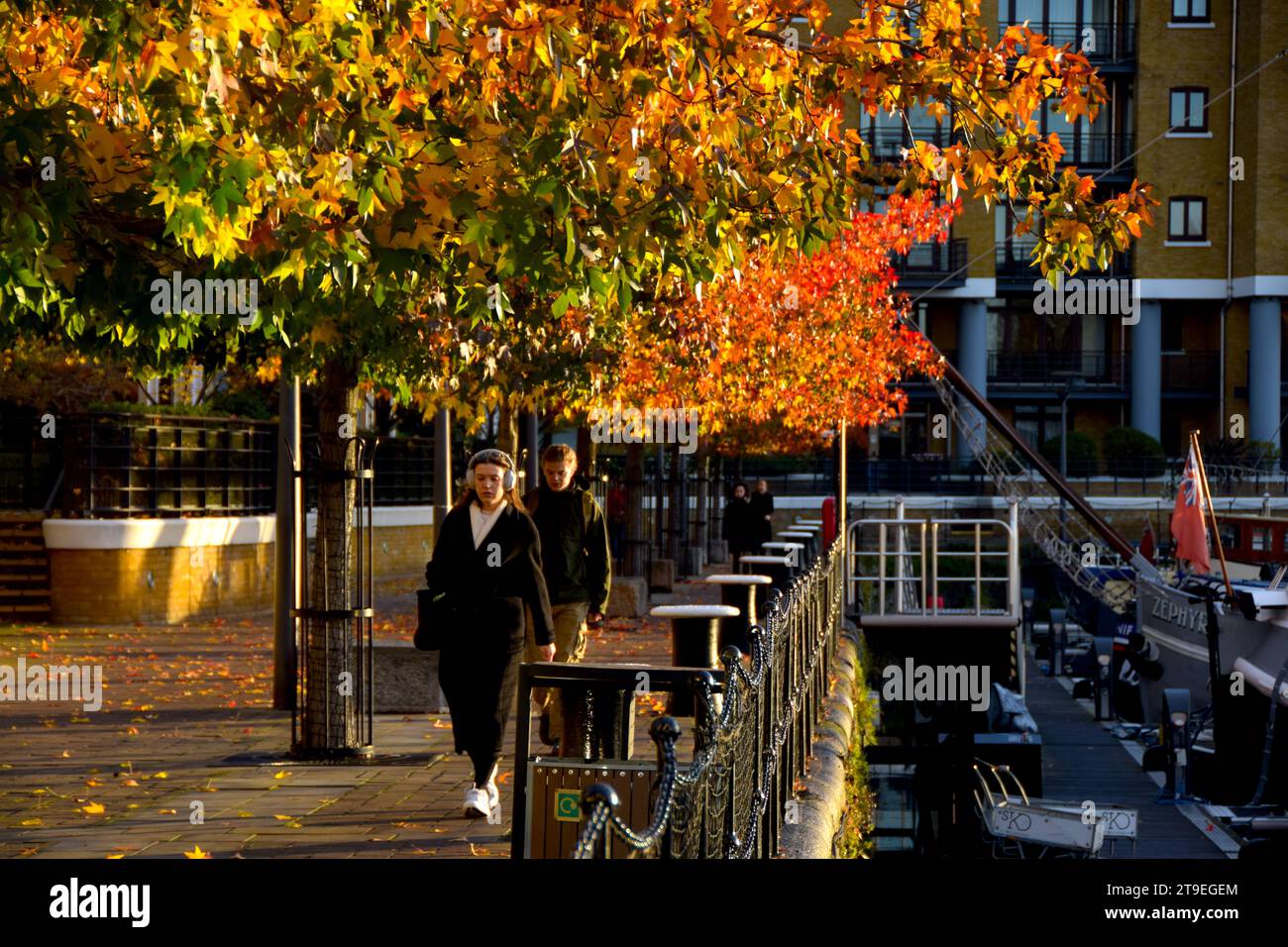 Winter colour on a week day in London. Image shows a walk way and ...