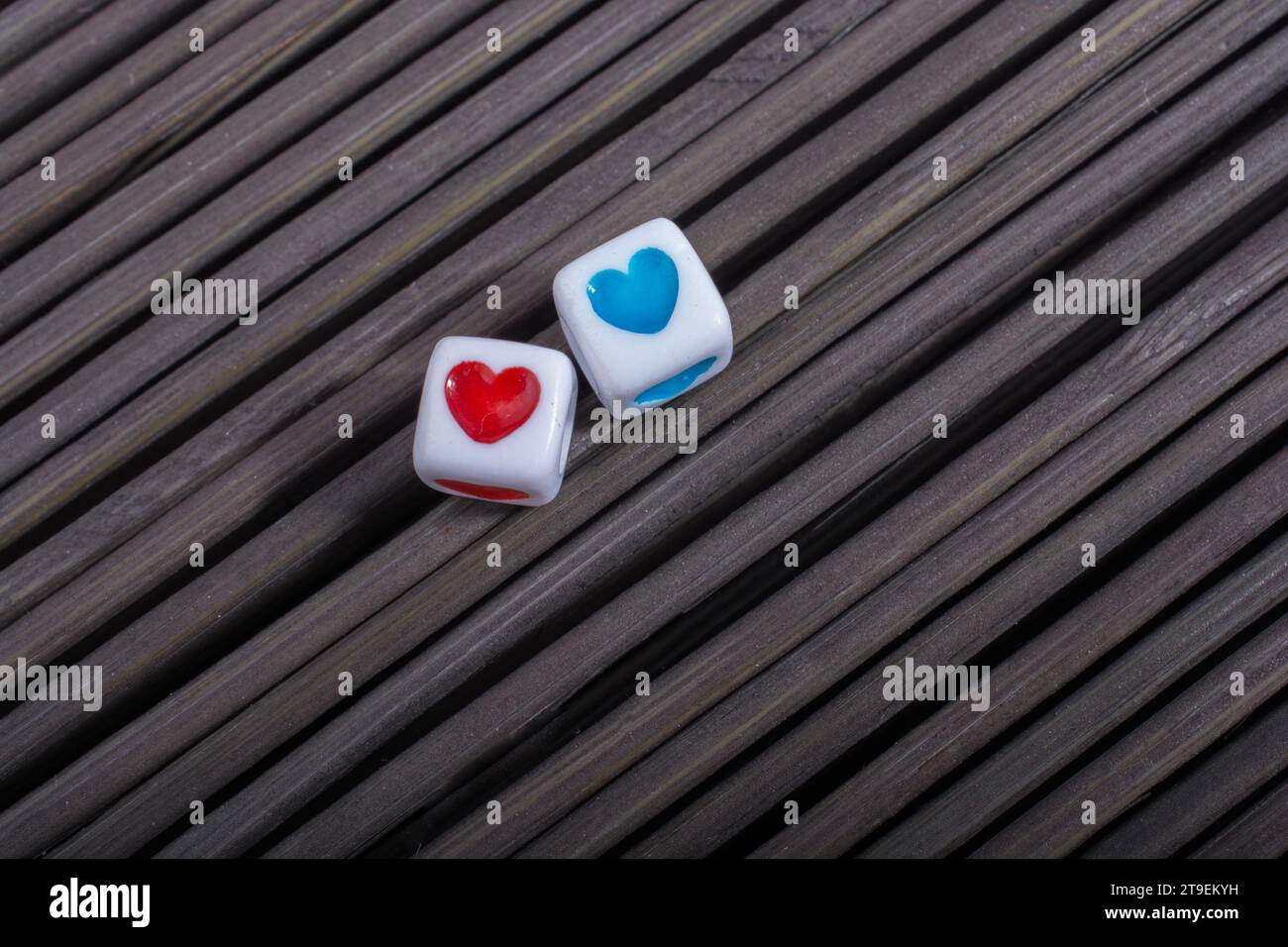 Colorful heart shaped love cubes on a straw mat Stock Photo - Alamy