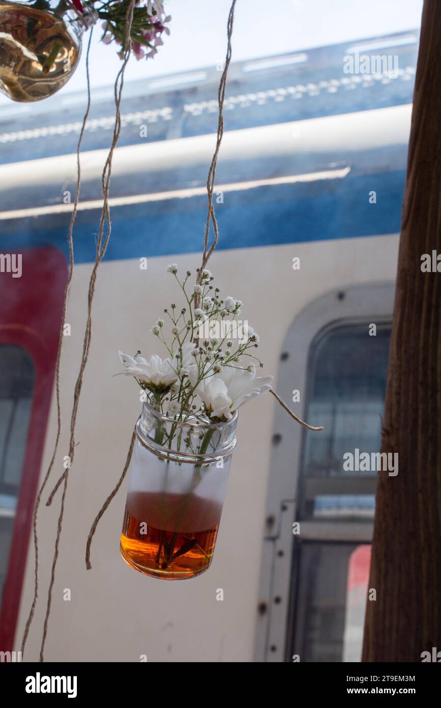 Herbal tea bottle with flowers hanging on string Stock Photo - Alamy