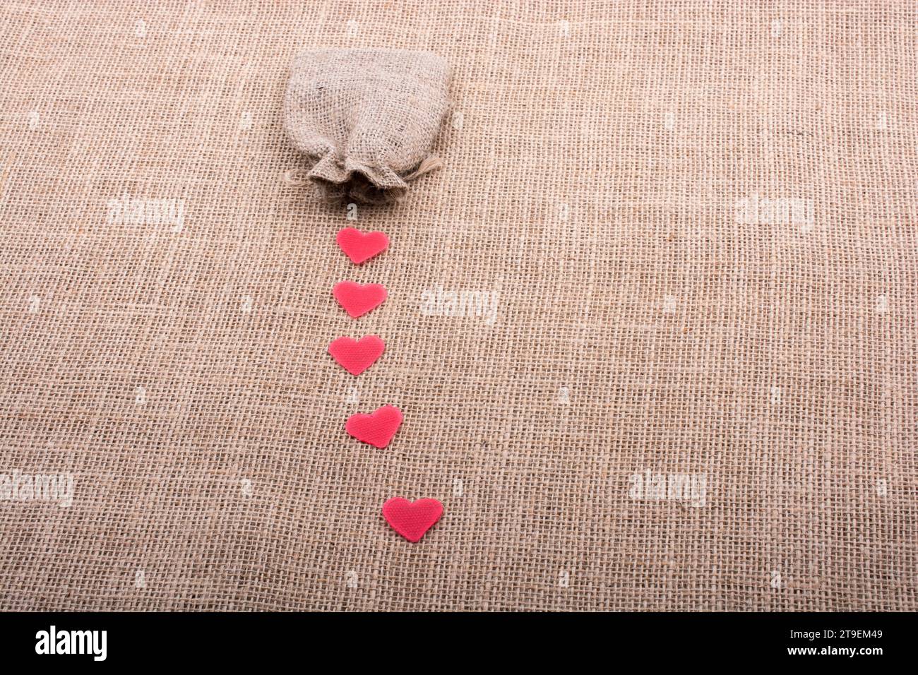 Heart shaped objects before a sack on canvas Stock Photo - Alamy