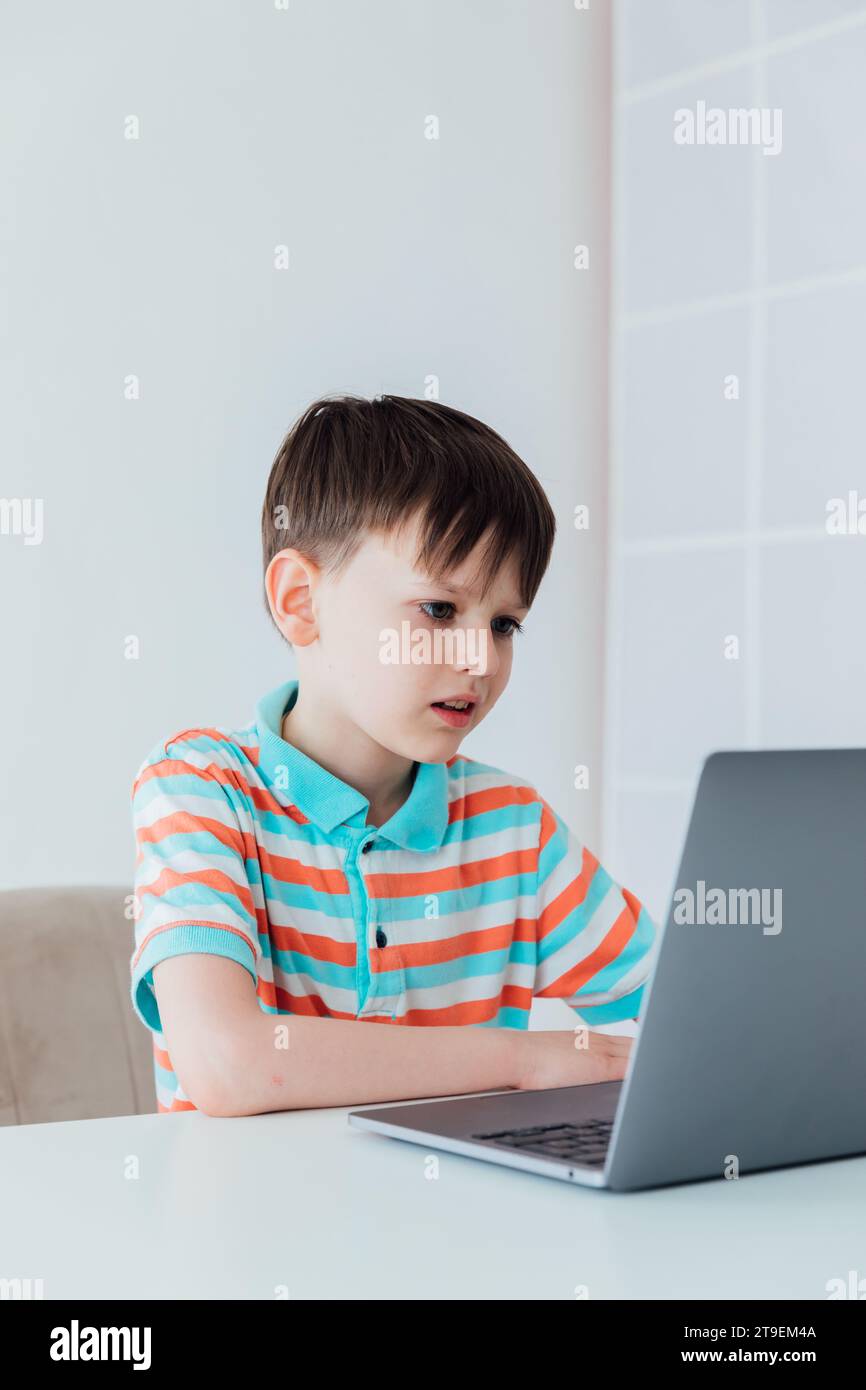 Boy with laptop online learning internet job Stock Photo - Alamy