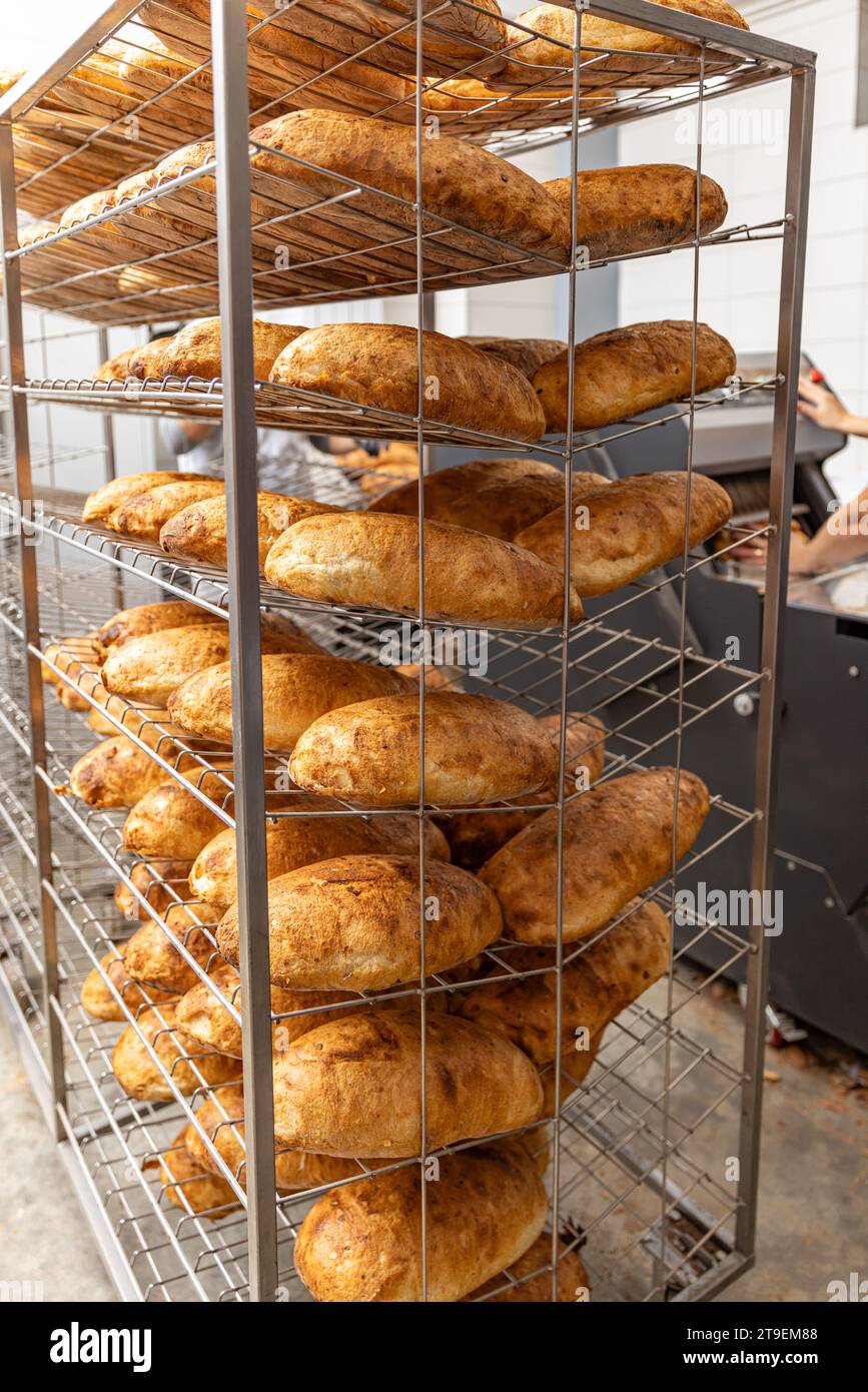 Fresh bread inside of a bakery ready to sell. Industrial food ...