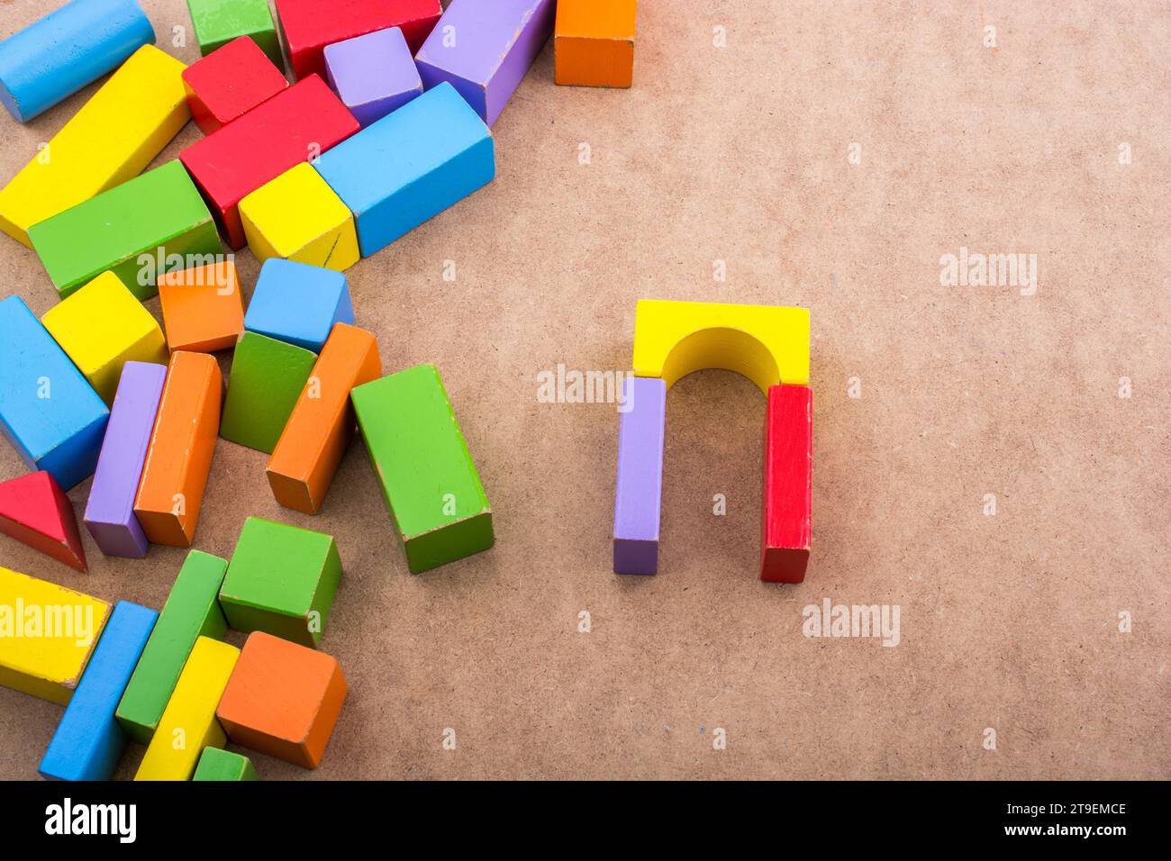 Colorful building blocks on a brown background Stock Photo - Alamy