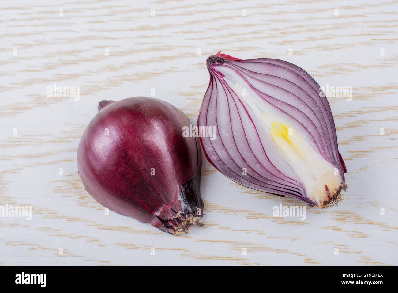 Red onion bulb cut in half on a certain background Stock Photo - Alamy