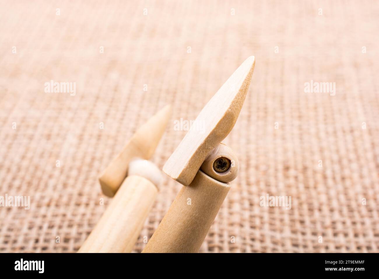 Wooden dolls posing with his legs on canvas Stock Photo - Alamy