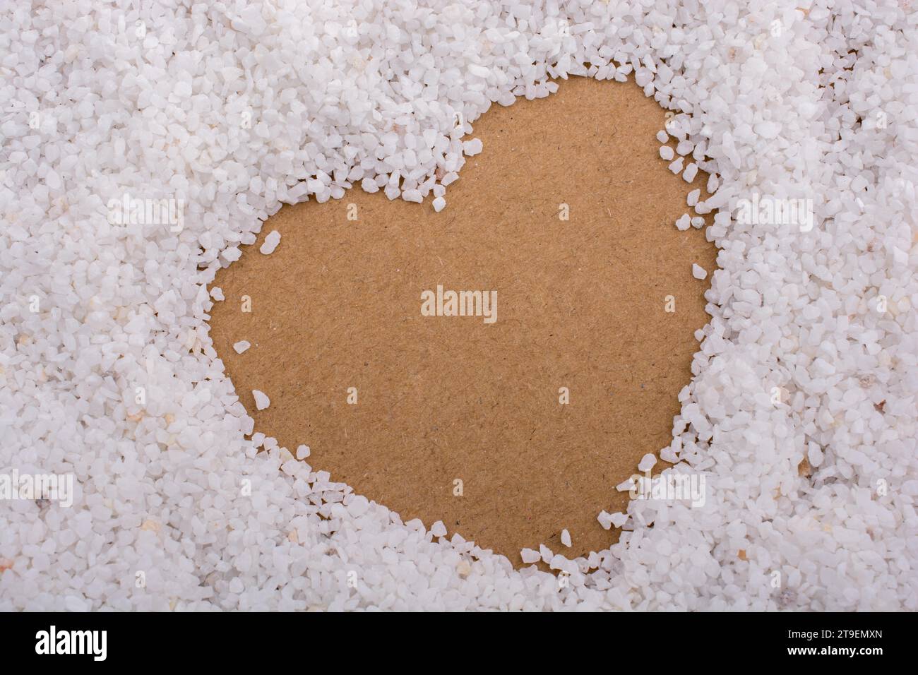 White heart stone on sand hi-res stock photography and images - Alamy