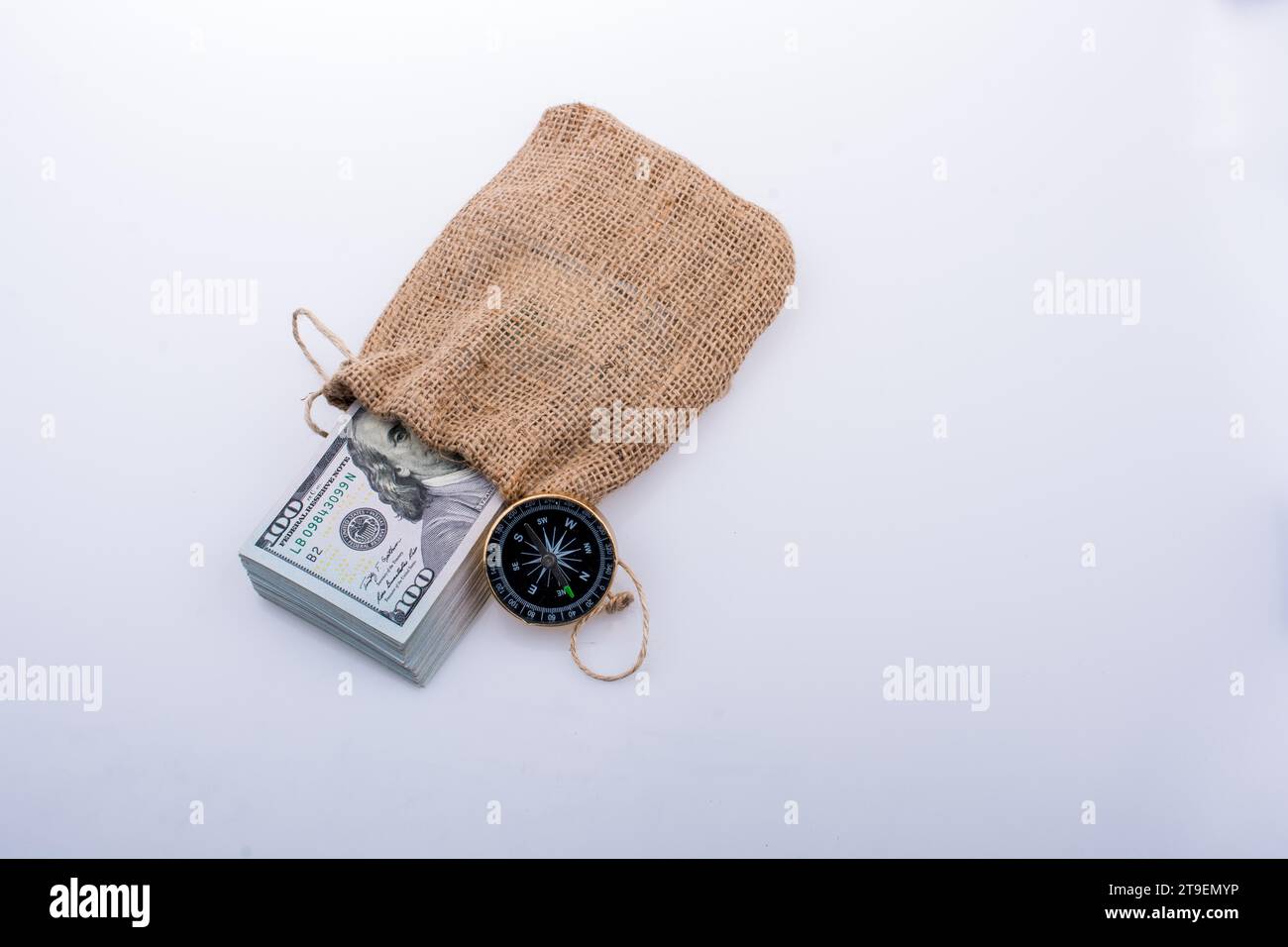 Compass and bundle of US dollarin a sack on a white background Stock ...