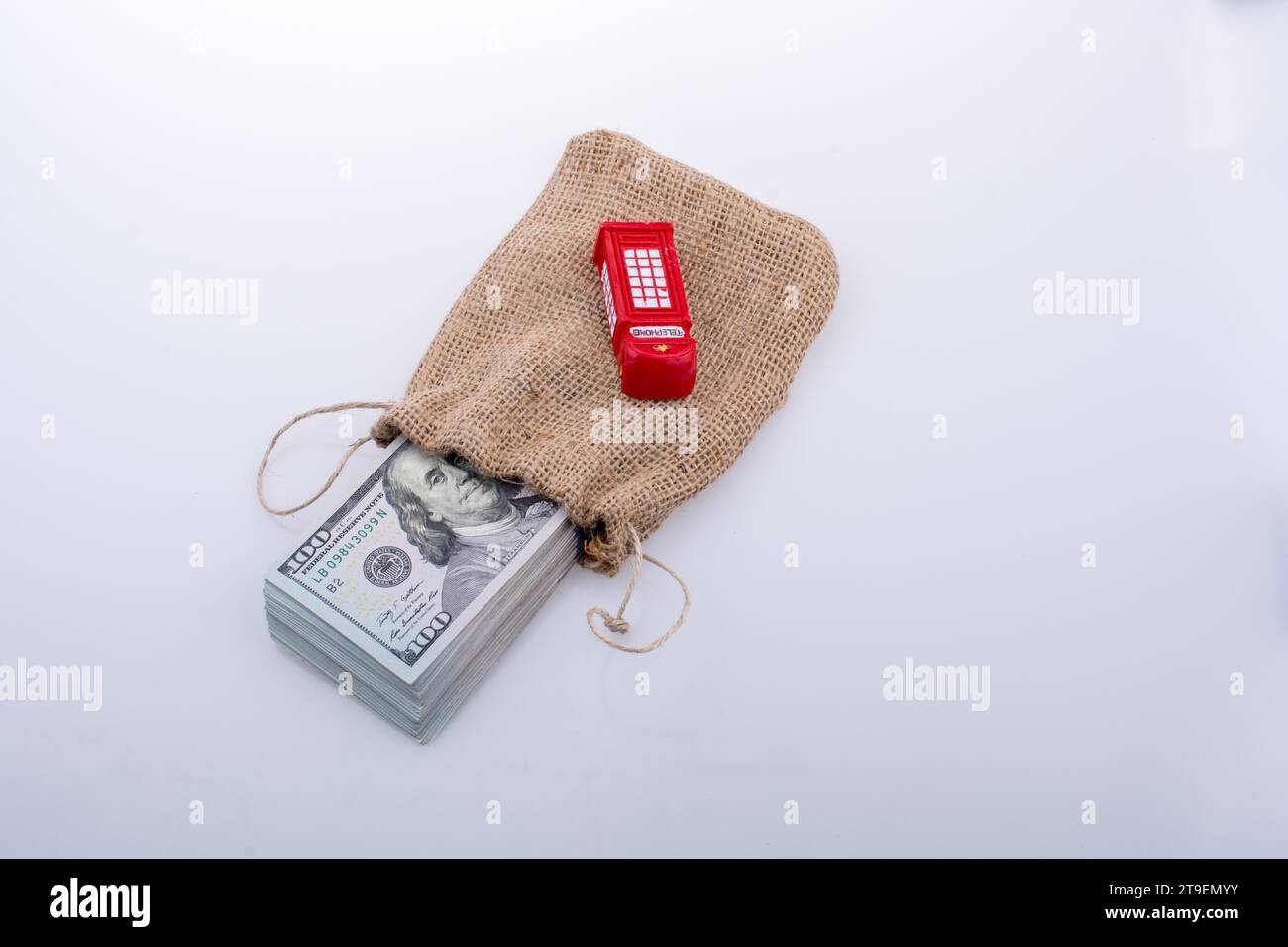 Telephone booth and banknote bundle of US dollar in a sack Stock Photo ...