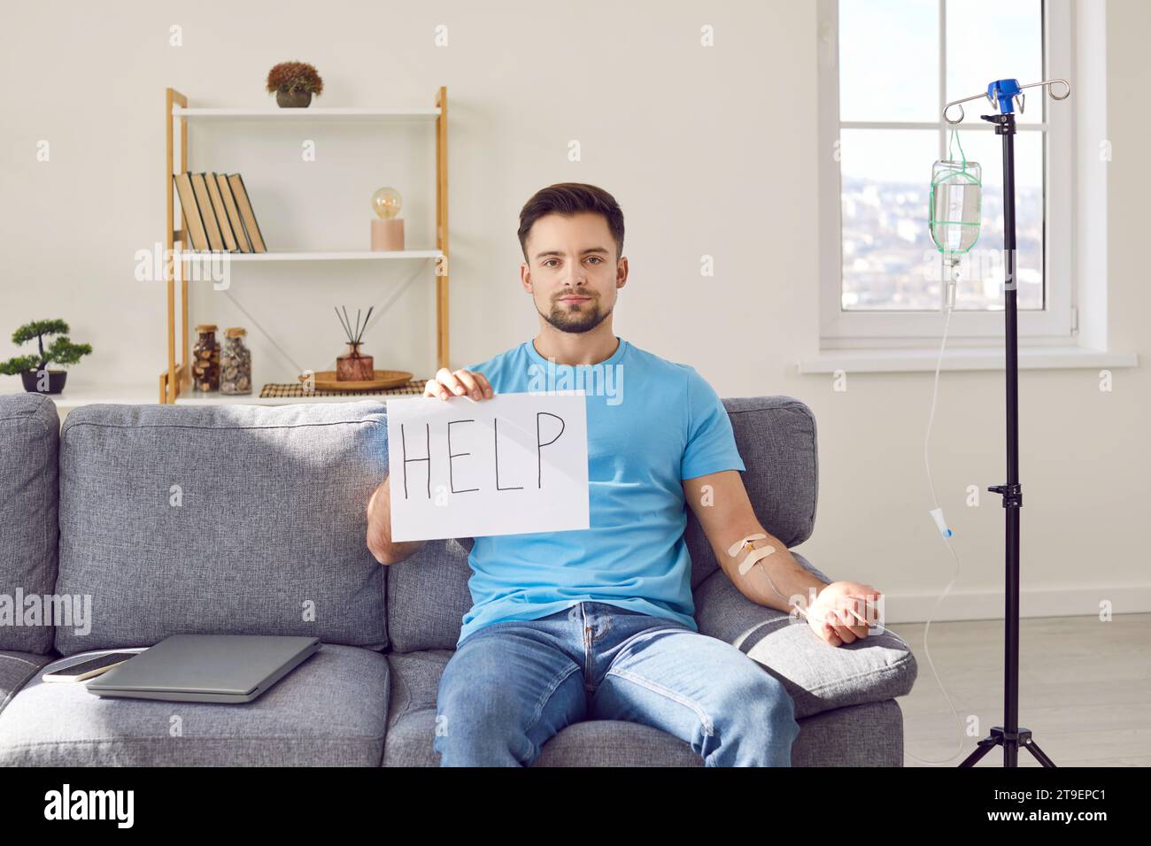 Sick young man getting intravenous IV line medical infusion therapy and ...