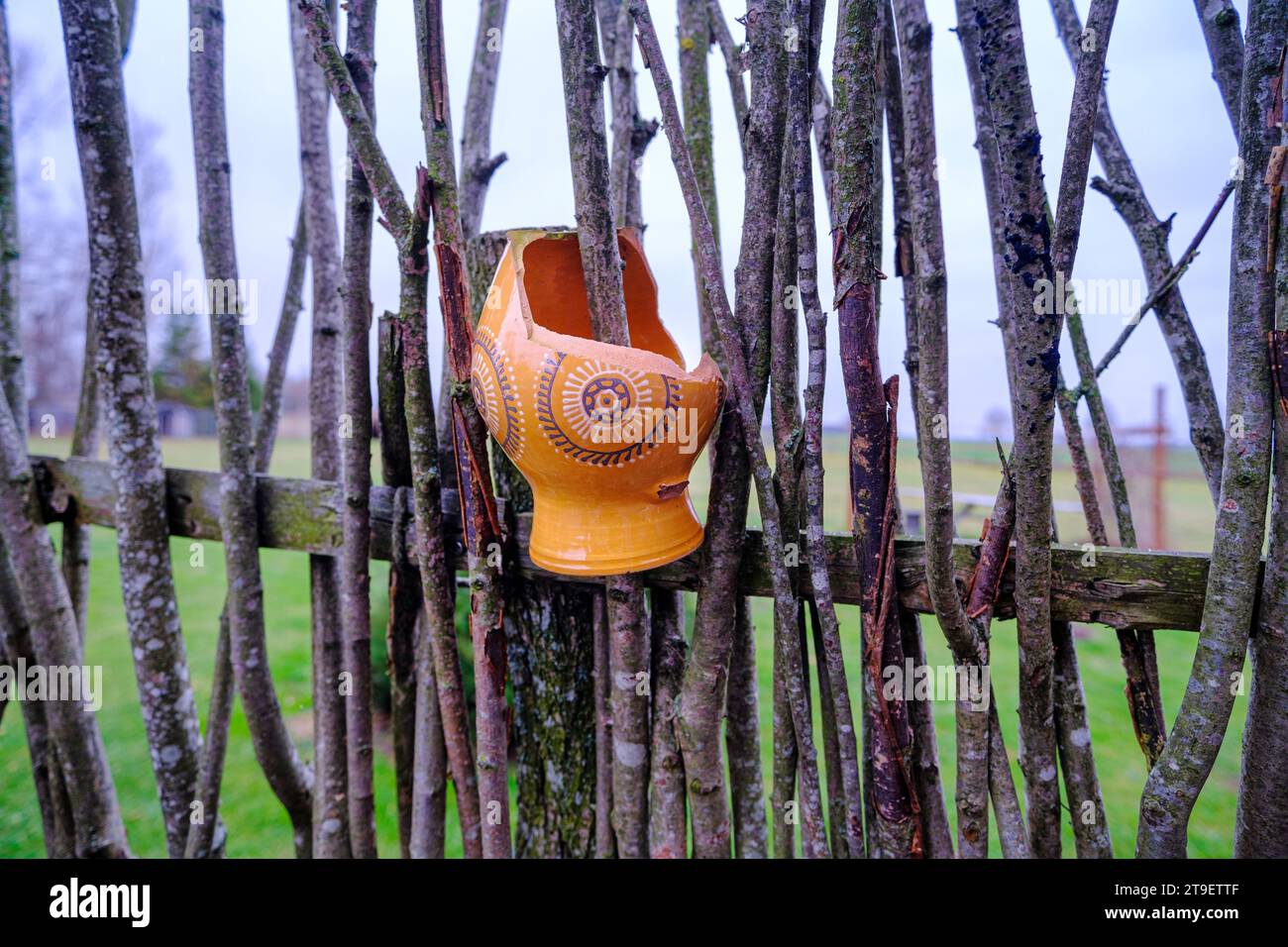 Old pitched pitcher like scenery in the garden. A broken clay mug on ...