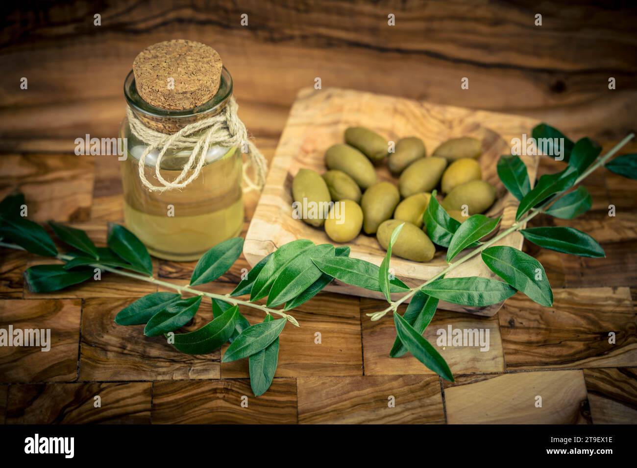 cold pressed extra virgin olive oil on olive wood Stock Photo - Alamy